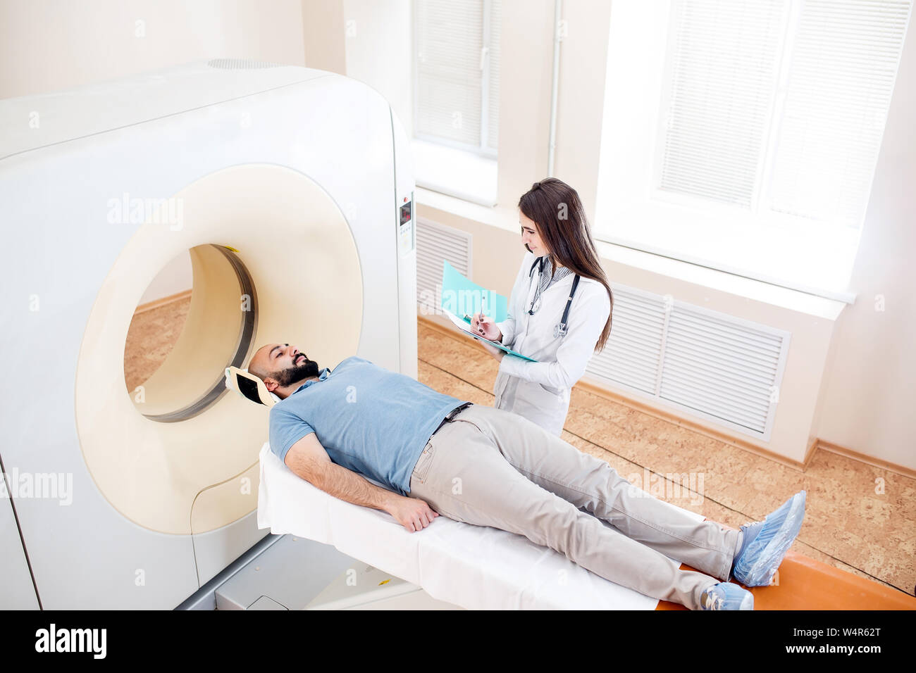 Happy patient undergoing mri scan at hospital Stock Photo - Alamy