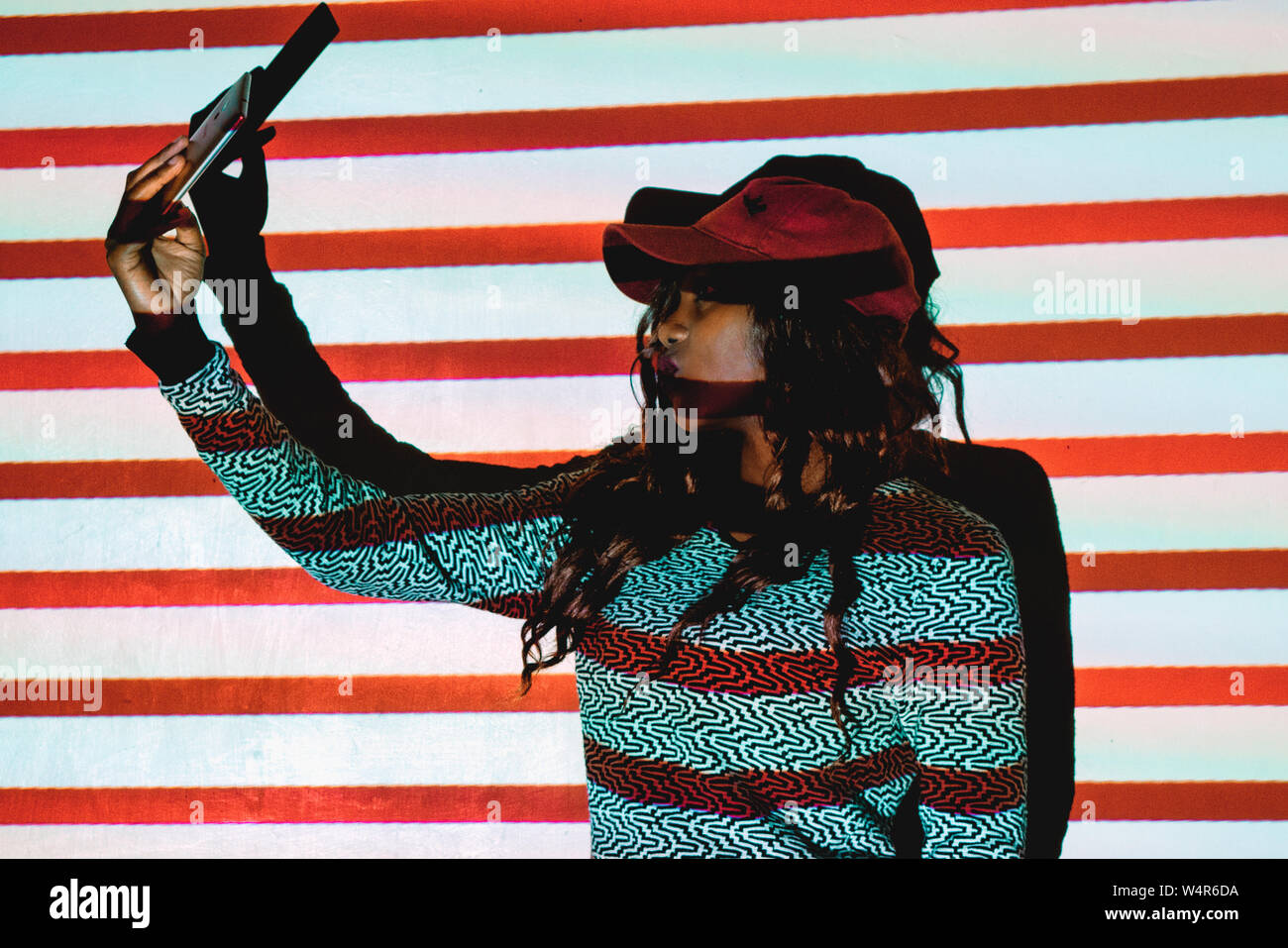 A girl on the background lit by a projector Stock Photo - Alamy