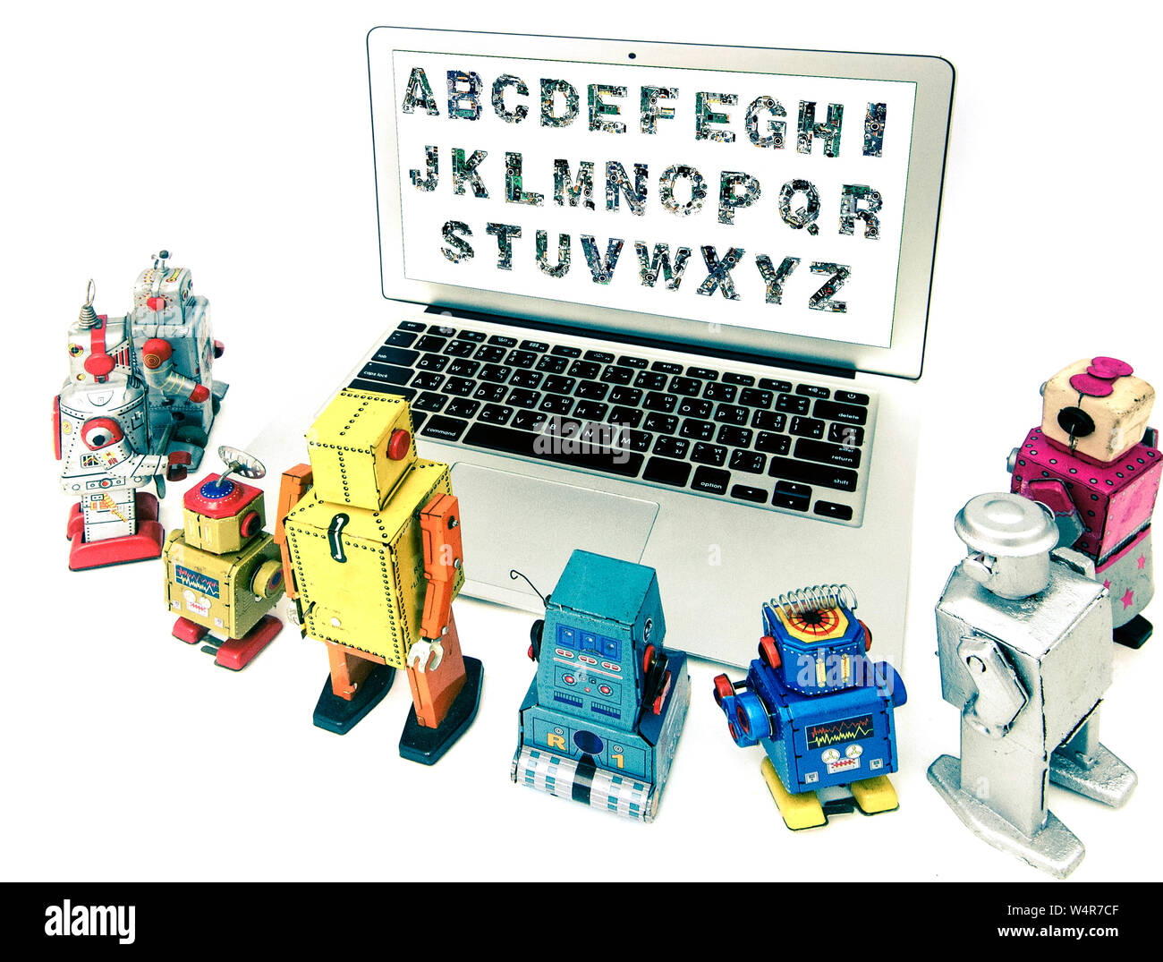 kid robot toys lear there alphabet on a laptop computer isolated on ...