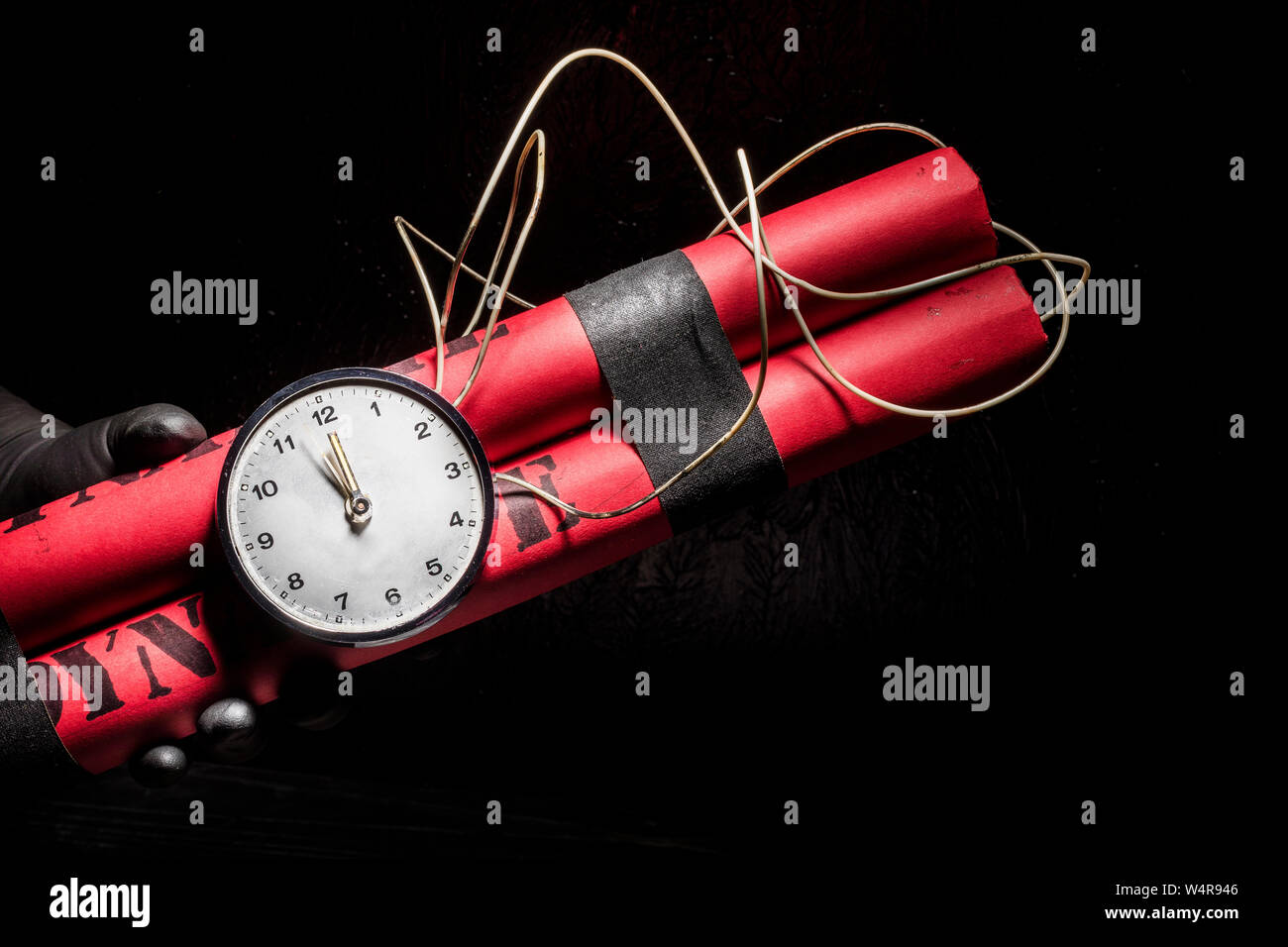 Dynamite bomb with a timer, and a bunch of dynamite on black background ...