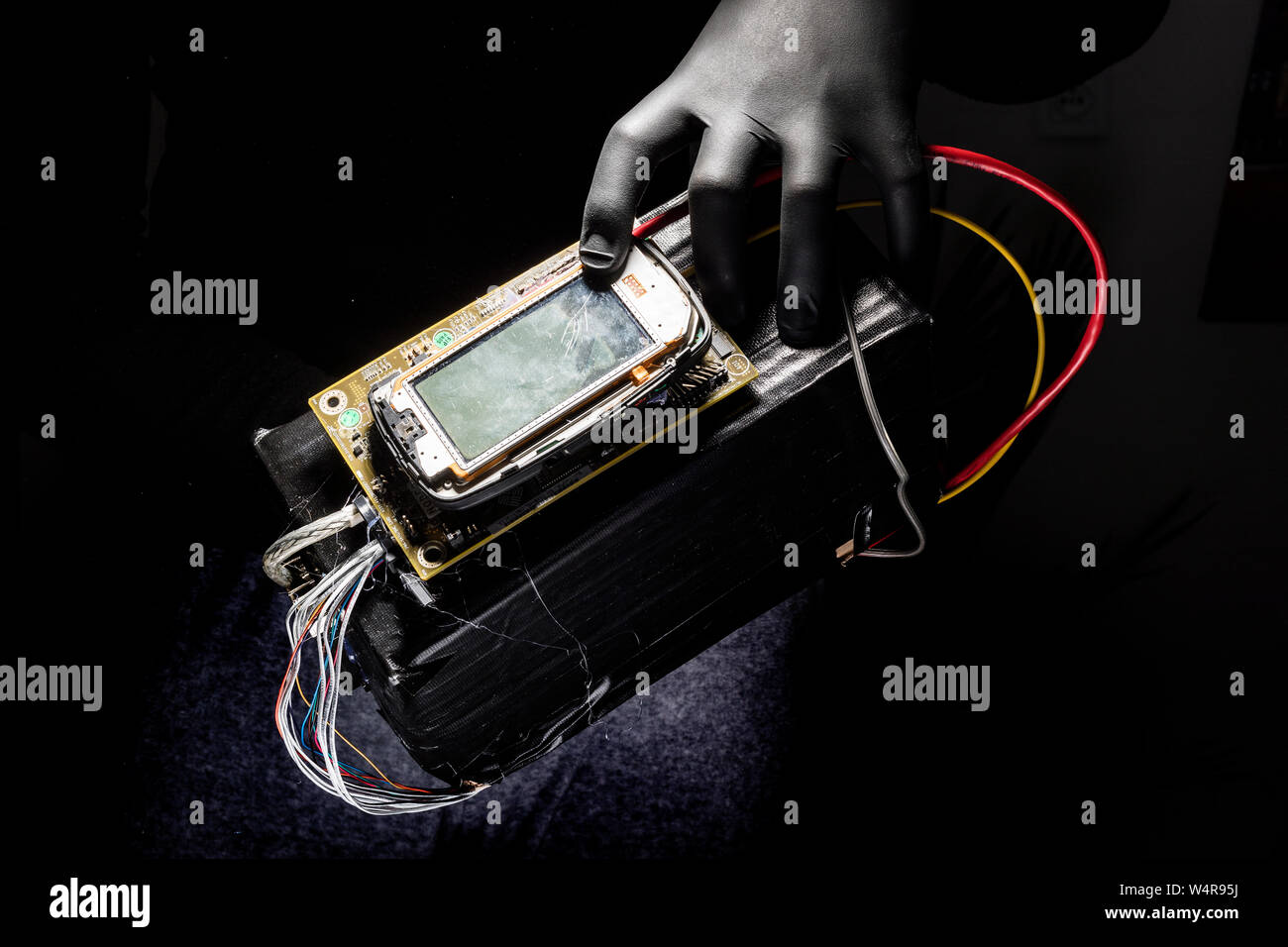 Terrorist is holding home made bomb with cables and remote controled ...