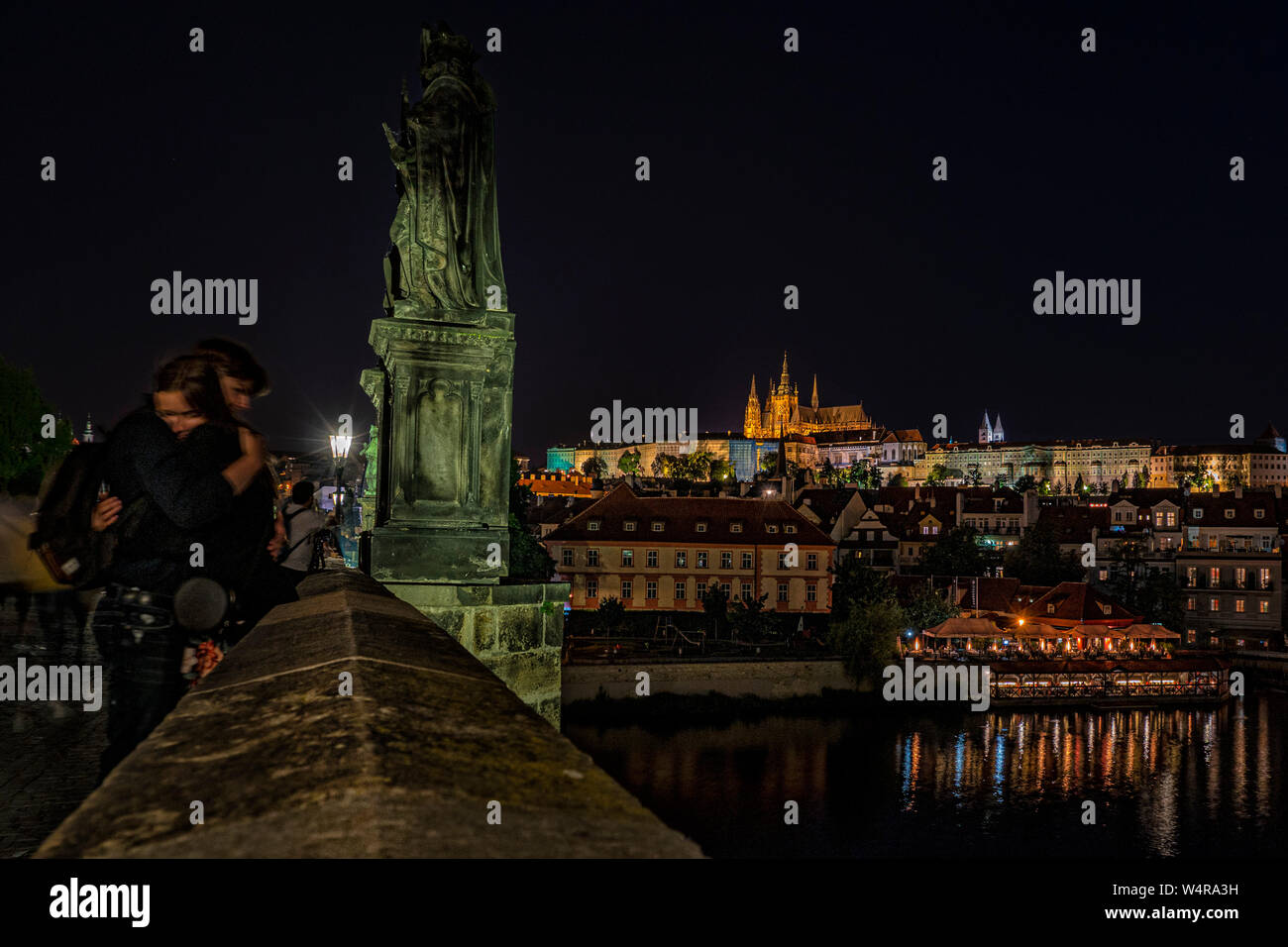 couple kissing on prague charles bridge at night prague charles bridge ...
