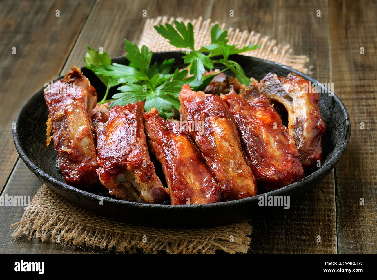 Roasted pork ribs in frying pan Stock Photo - Alamy
