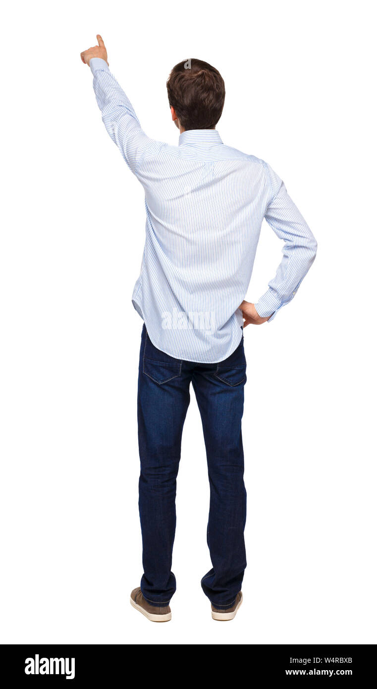 Back view of a man in jeans points his hand upwards. Rear view people ...