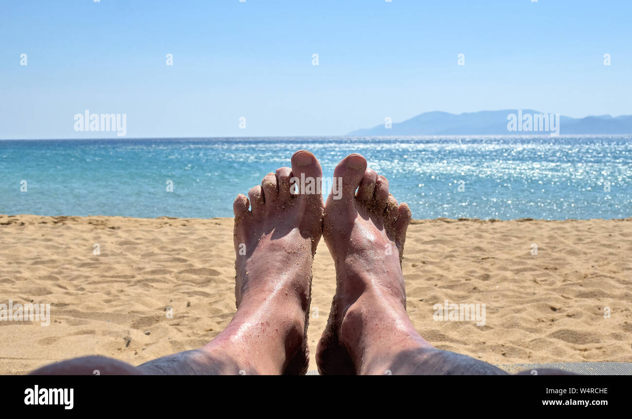 Close up view on legs on beach with the horizon line Stock Photo - Alamy