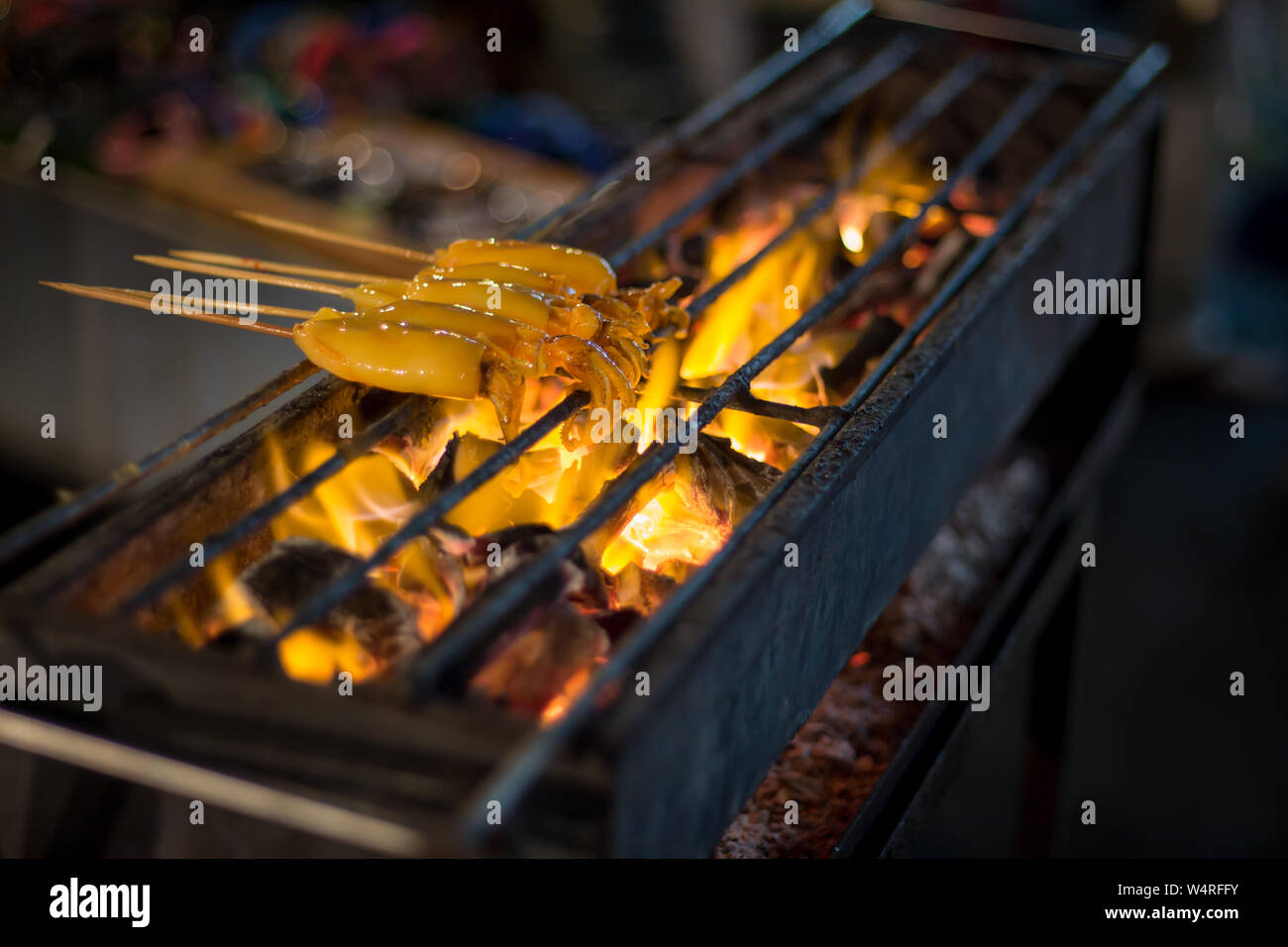 Squid on the grill with a flame Stock Photo - Alamy