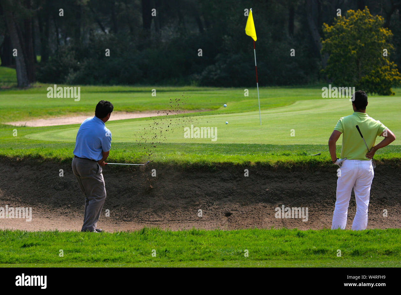 man golfer in action on a golf course Stock Photo - Alamy