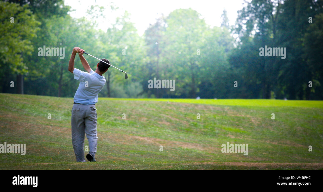 man golfer in action on a golf course Stock Photo - Alamy