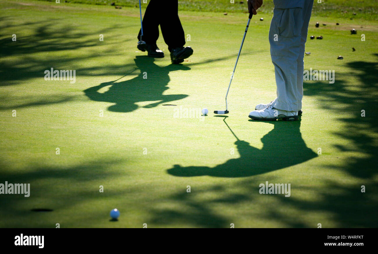 man golfer in action on a golf course Stock Photo - Alamy