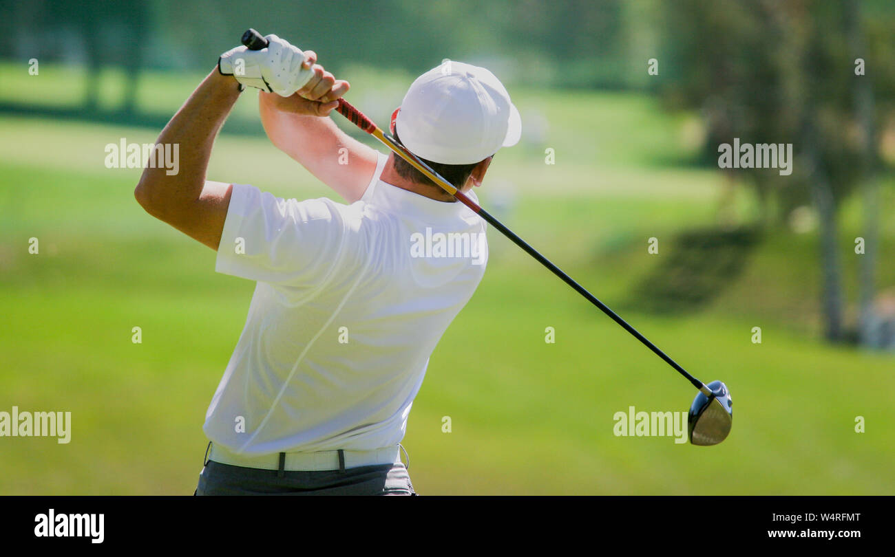 man golfer in action on a golf course Stock Photo - Alamy