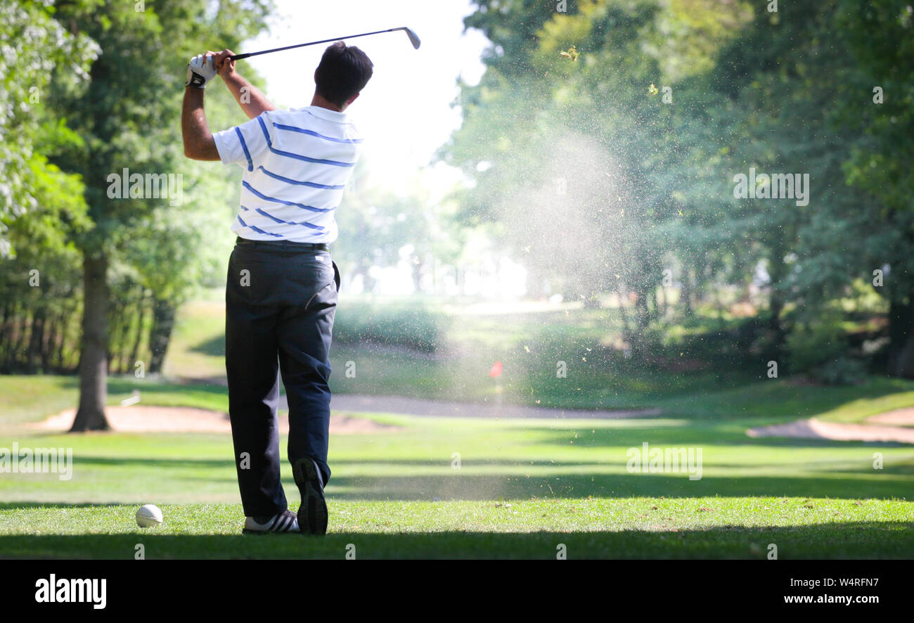man golfer in action on a golf course Stock Photo - Alamy