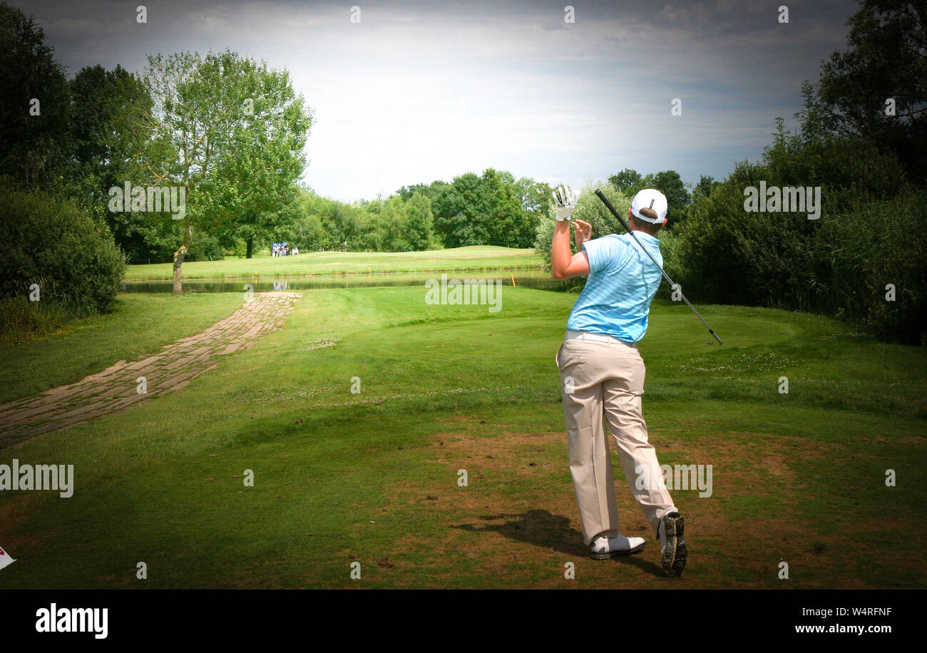 man golfer in action on a golf course Stock Photo - Alamy