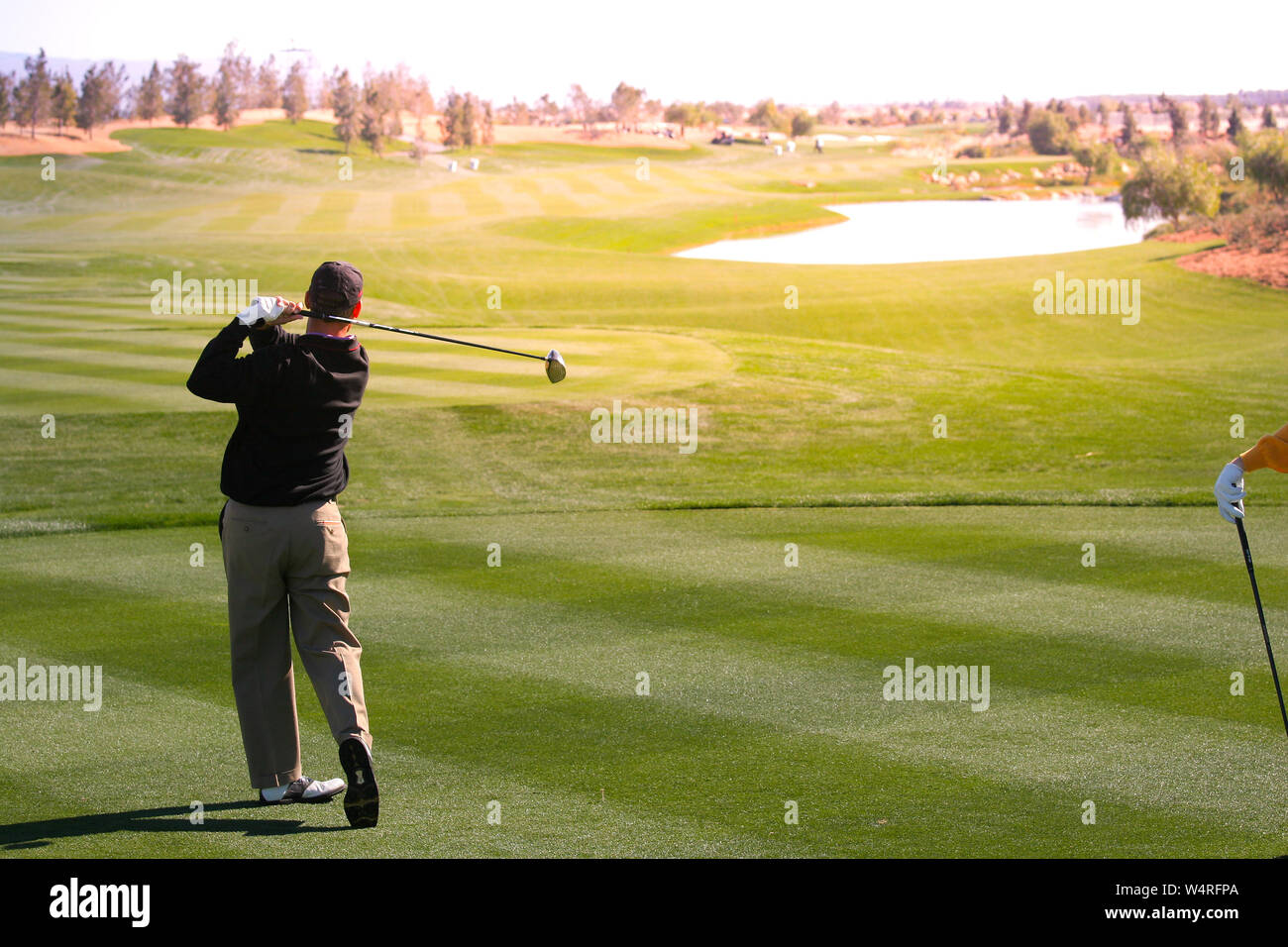 man golfer in action on a golf course Stock Photo - Alamy