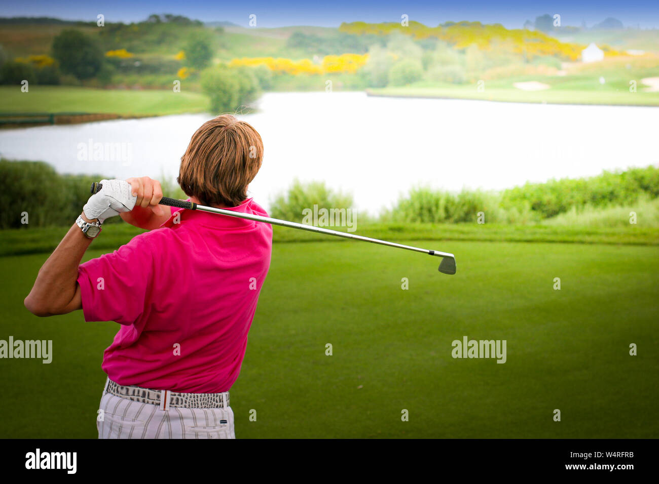 man golfer in action on a golf course Stock Photo - Alamy