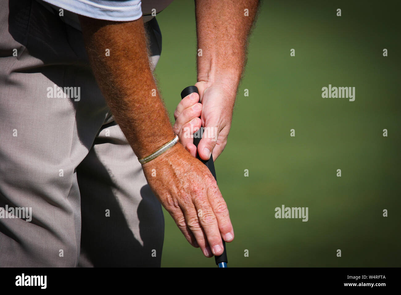 man golfer in action on a golf course Stock Photo - Alamy