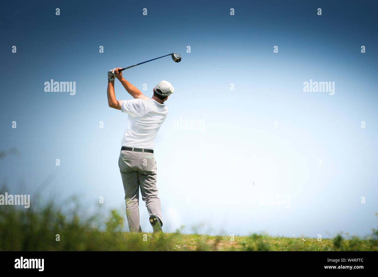 man golfer in action on a golf course Stock Photo - Alamy