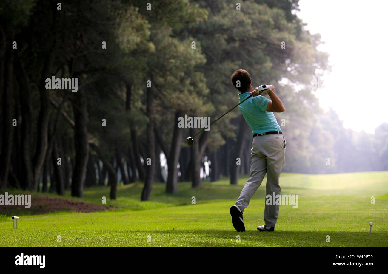 man golfer in action on a golf course Stock Photo - Alamy