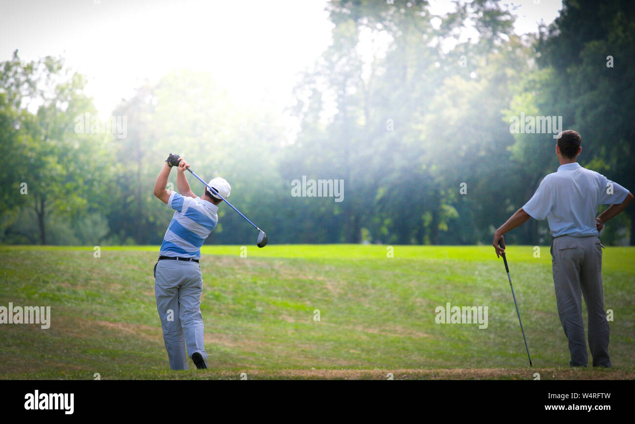 man golfer in action on a golf course Stock Photo - Alamy