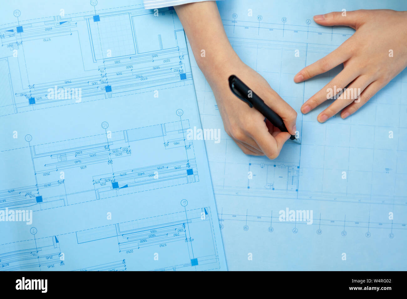 Architect drawing blueprints, Beijing, China Stock Photo - Alamy