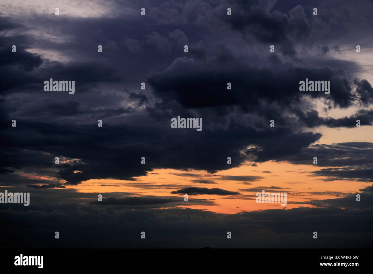 Beautiful sunset - dark sky with clouds and sunlight Stock Photo - Alamy
