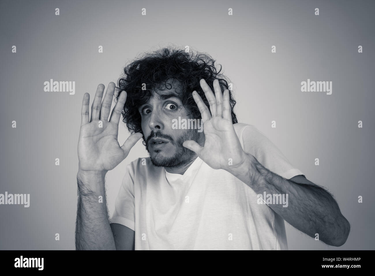 Portrait of young man in shock with scared face making frightened ...
