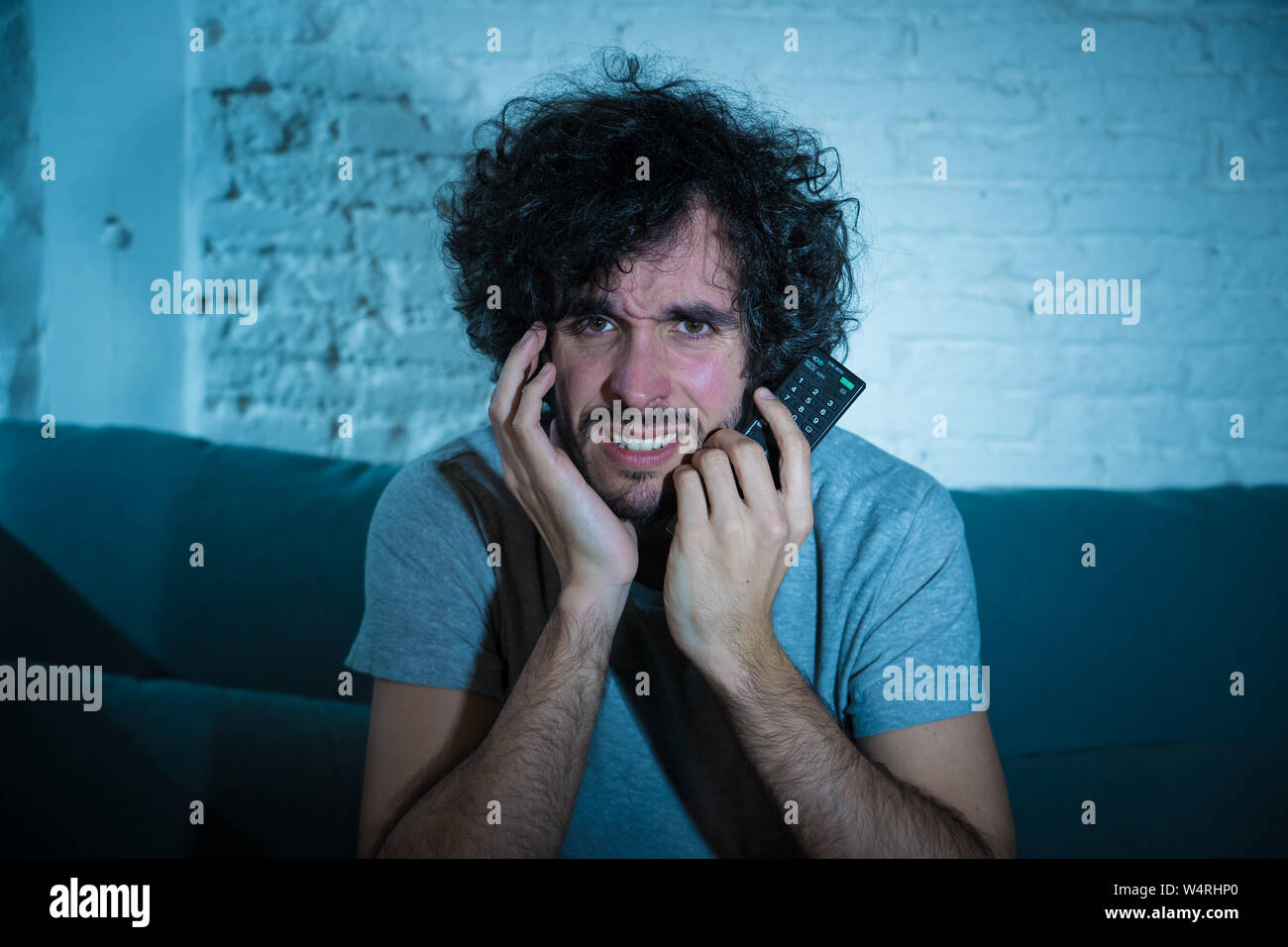 Lifestyle portrait of young disgust man watching horror movie or ...