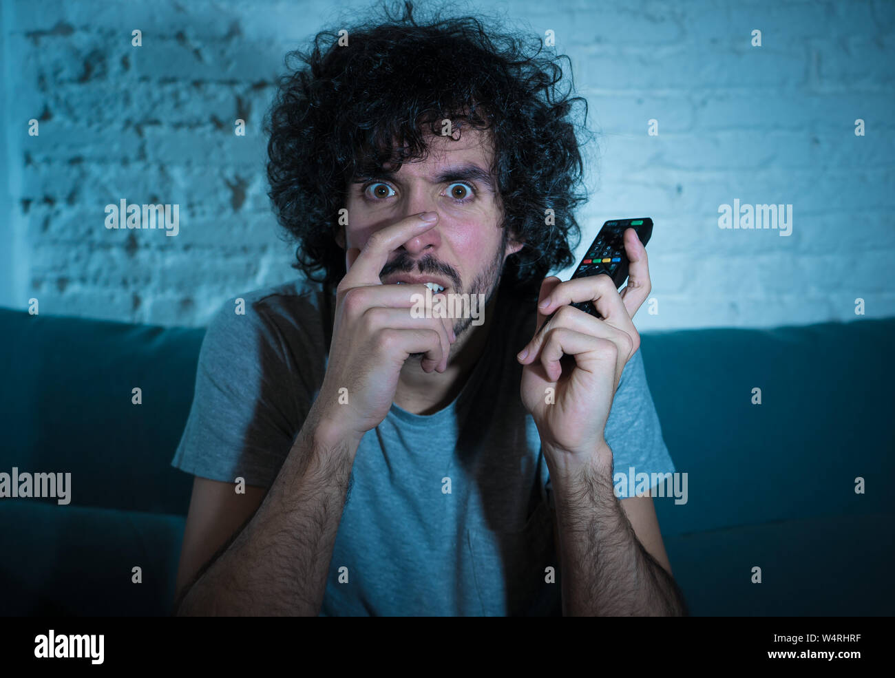 Lifestyle portrait of young man feeling scared and shocked making fear ...