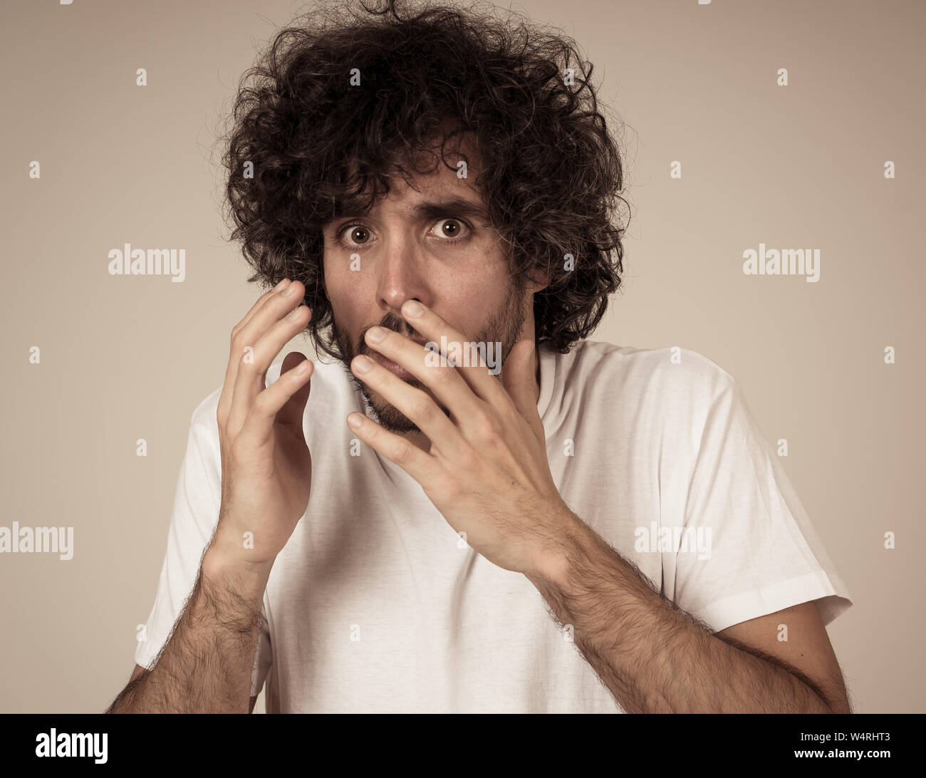 Portrait of young man in shock with scared face making frightened ...