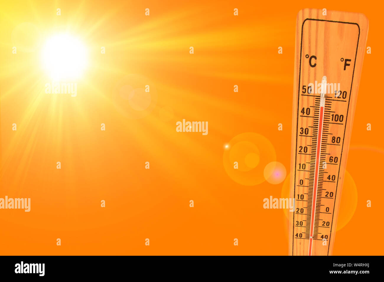 Sunny summer background with the thermometer marking a temperature over ...