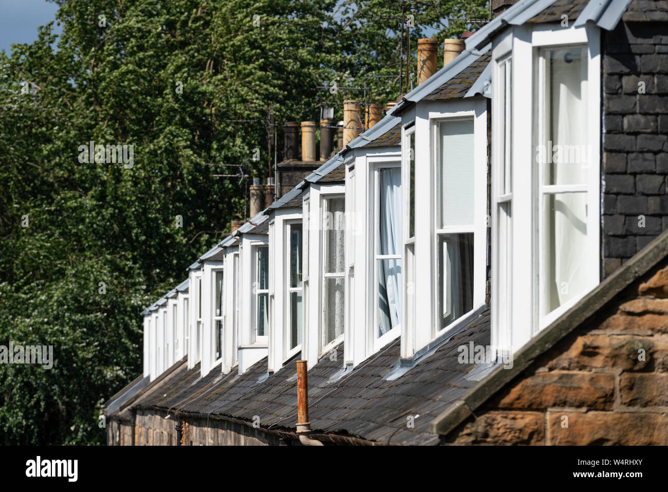 Exterior view of row of windows of Colony style terraced houses in ...