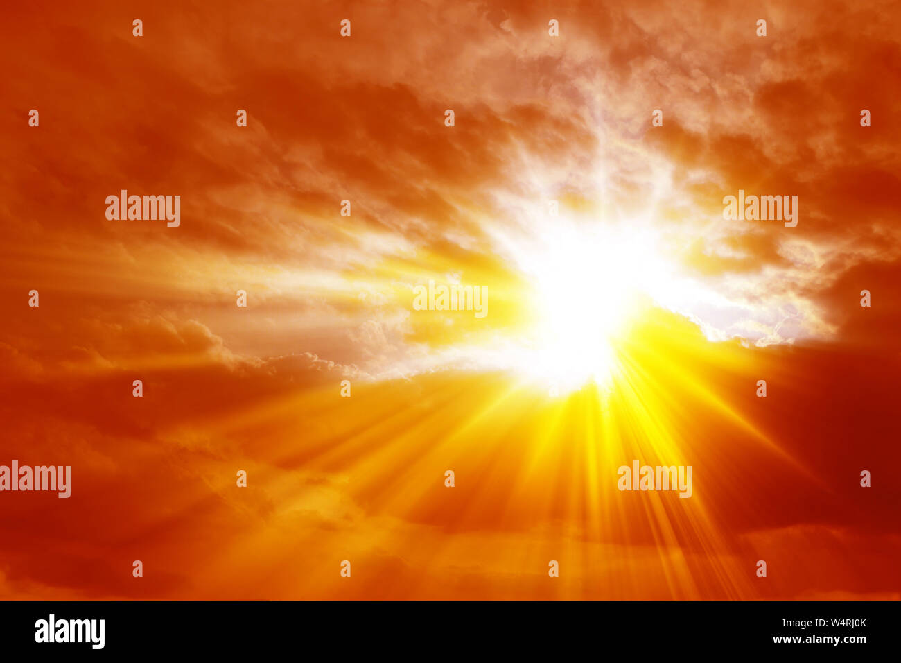 Rays of sunlight crossing the clouds in a fiery red sky Stock Photo - Alamy