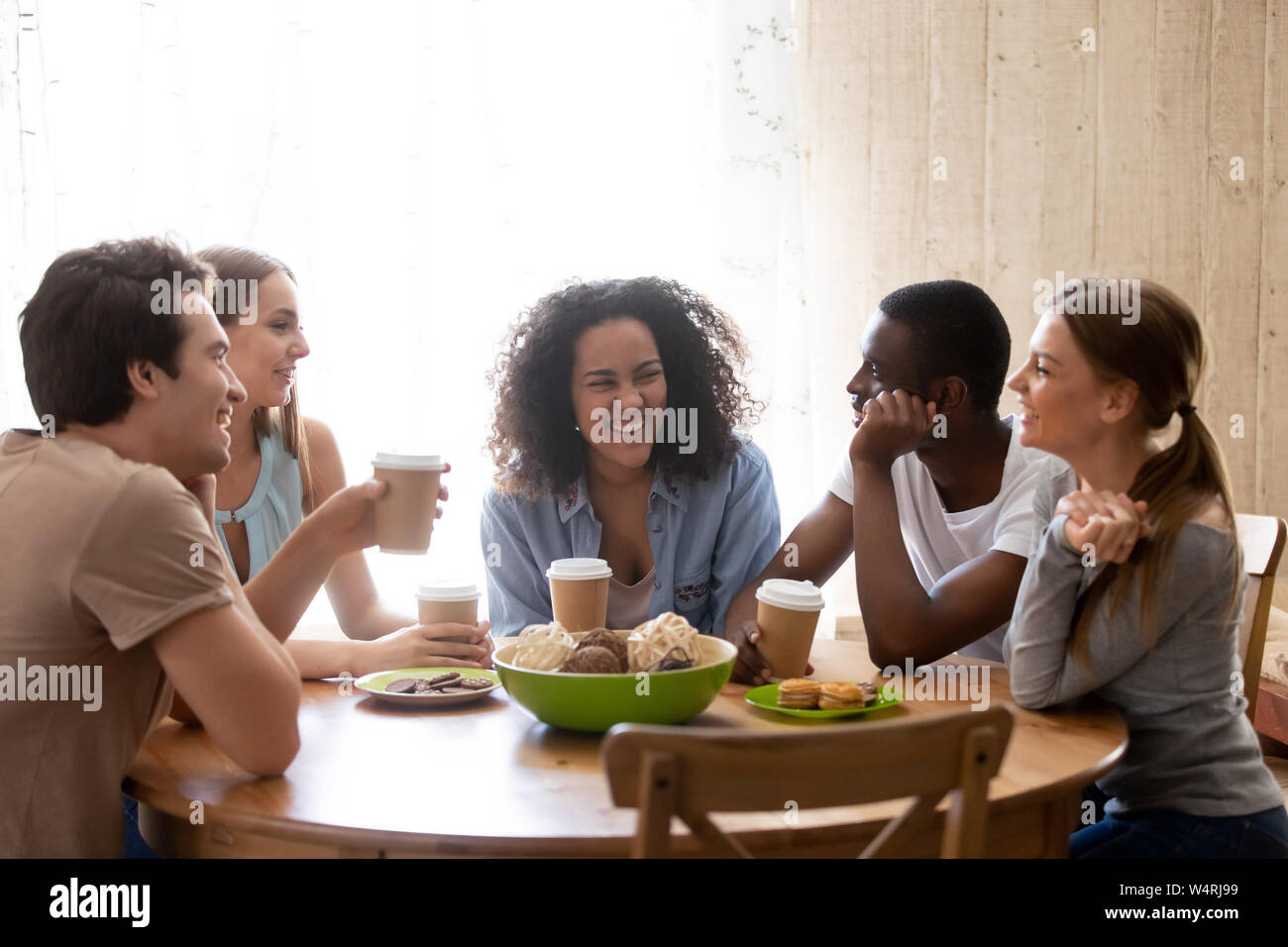 Happy mixed race group of best friends meeting Stock Photo - Alamy