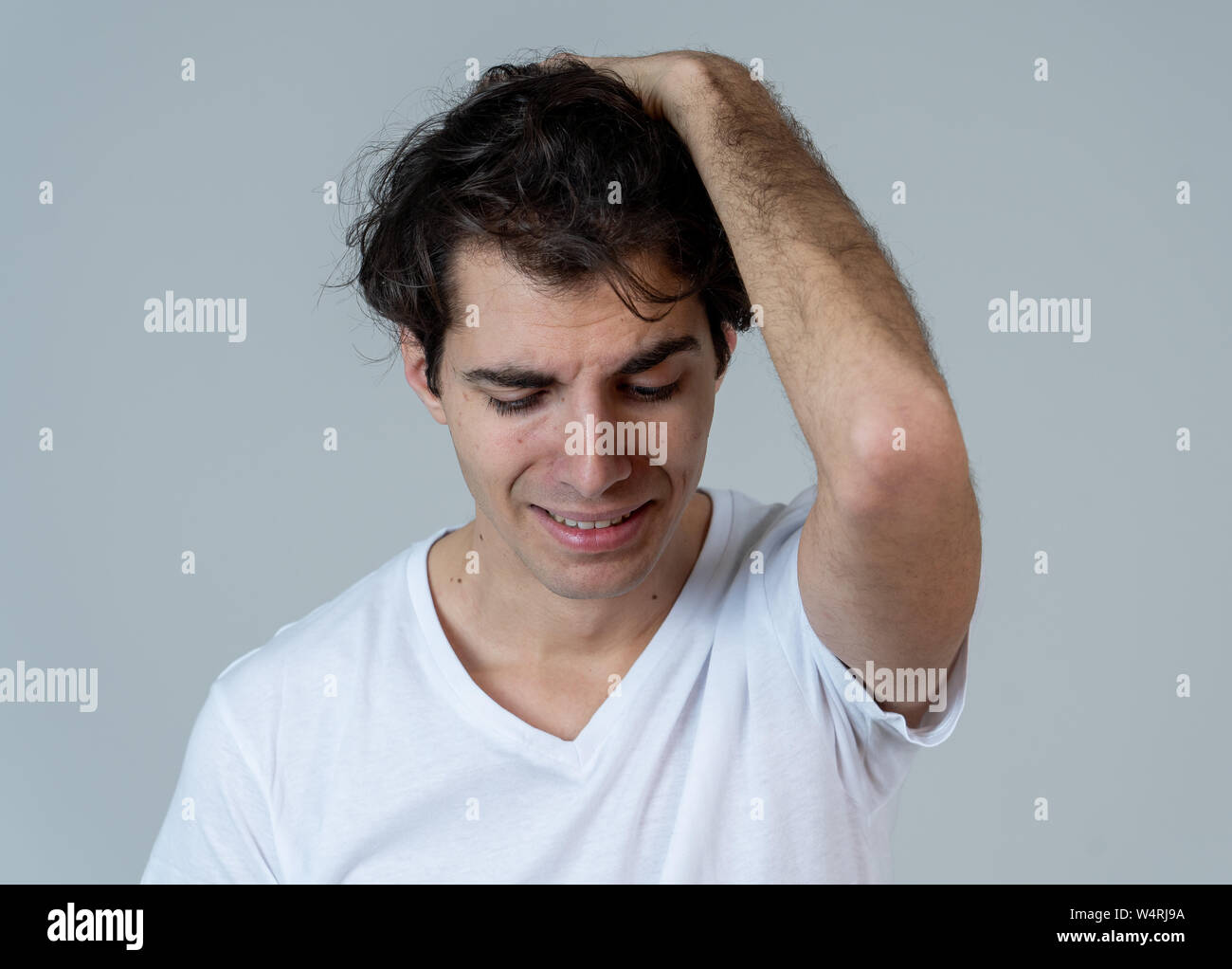 Portrait of young sad man crying in emotional pain looking desperate ...