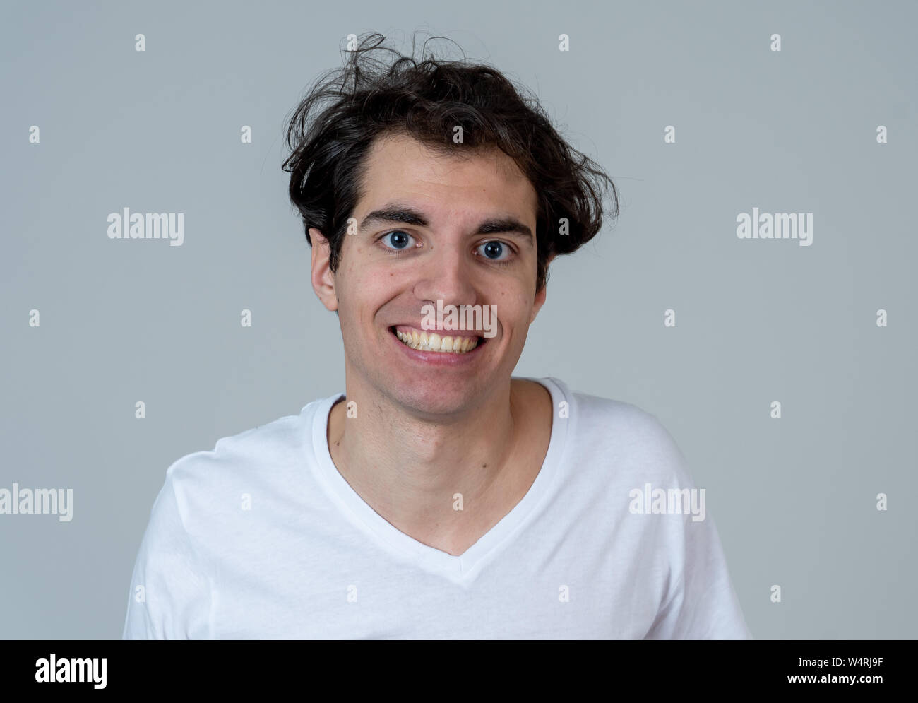 Close up portrait of happy young caucasian latin man wearing white T ...