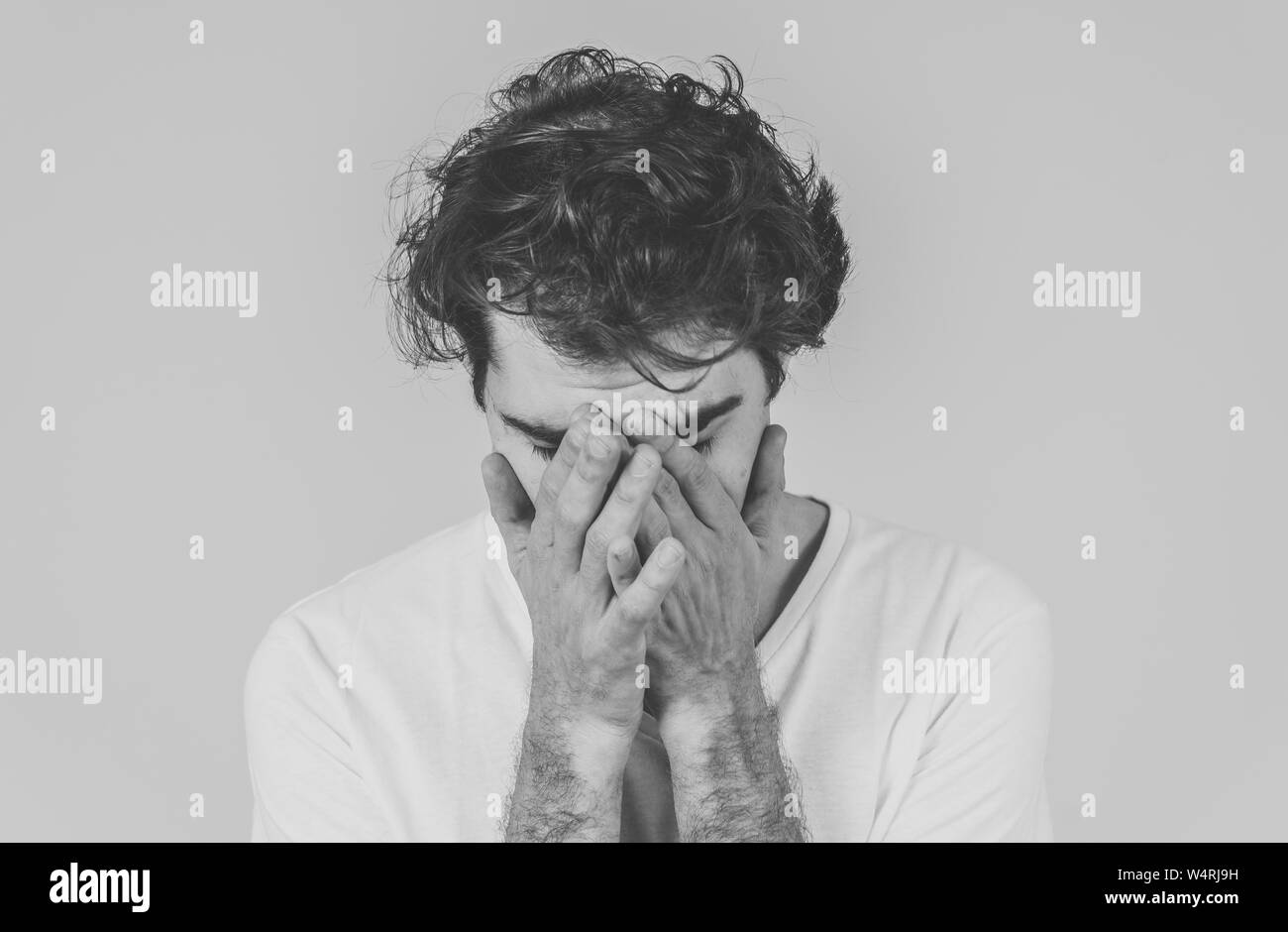 Portrait of young sad man crying in emotional pain looking desperate ...