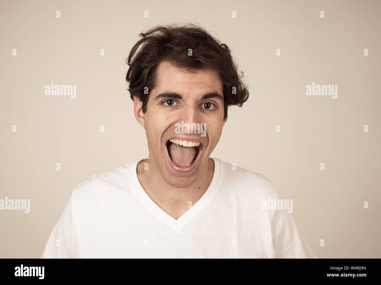 Close up portrait of happy young caucasian latin man wearing white T ...