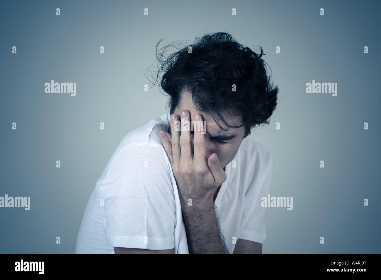 Young man feeling frightened and shocked making scared gestures in fear ...