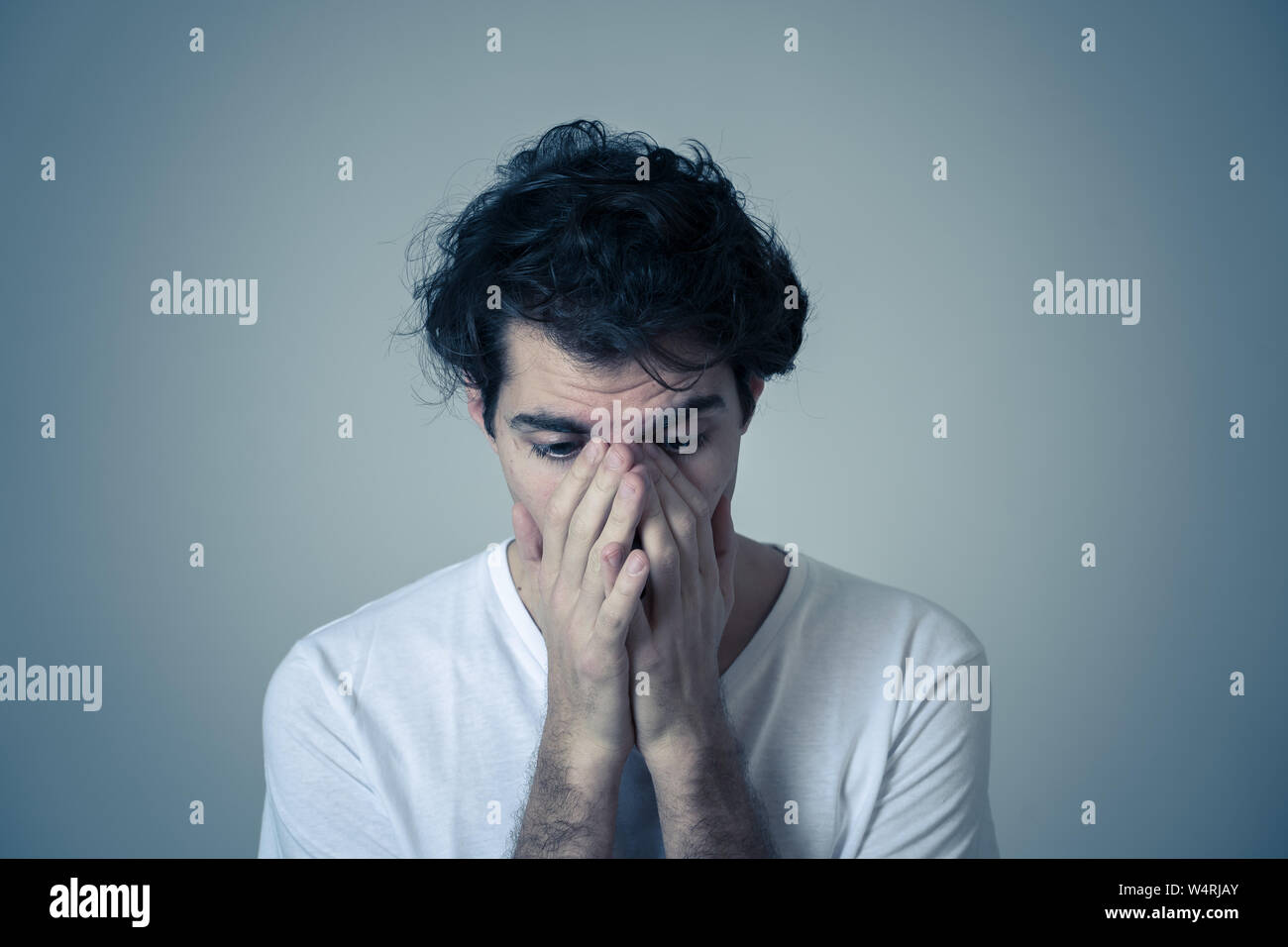 Portrait of young sad man crying in emotional pain looking desperate ...