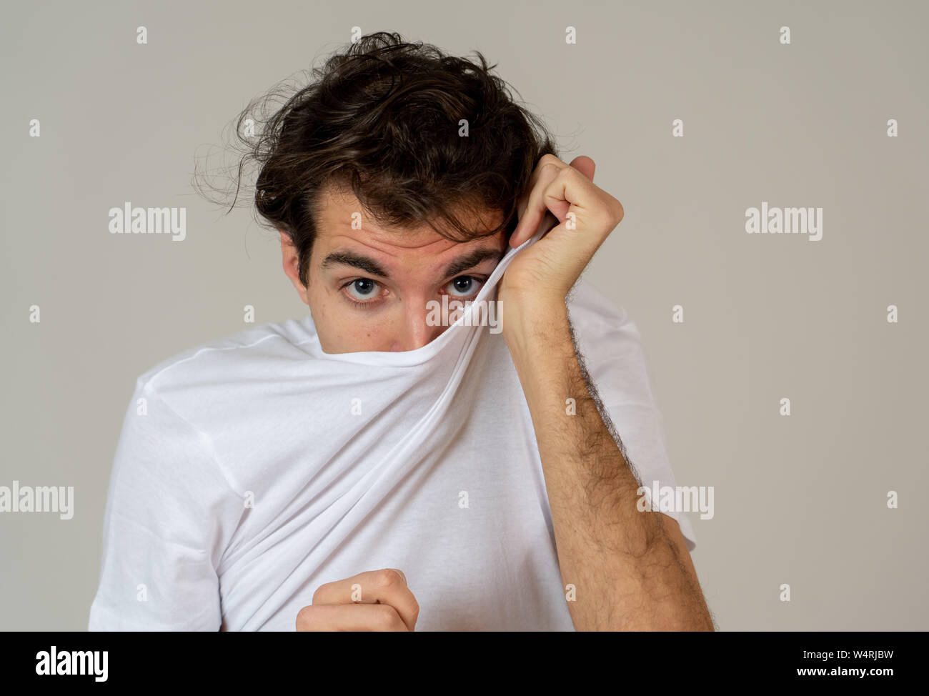 Young man feeling frightened and shocked making scared gestures in fear ...