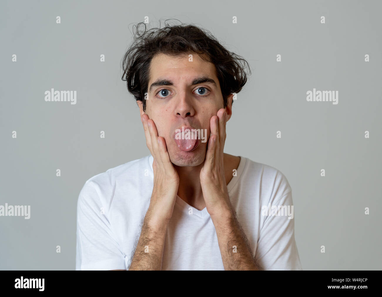 Portrait of young happy man with funny hilarious faces having fun ...