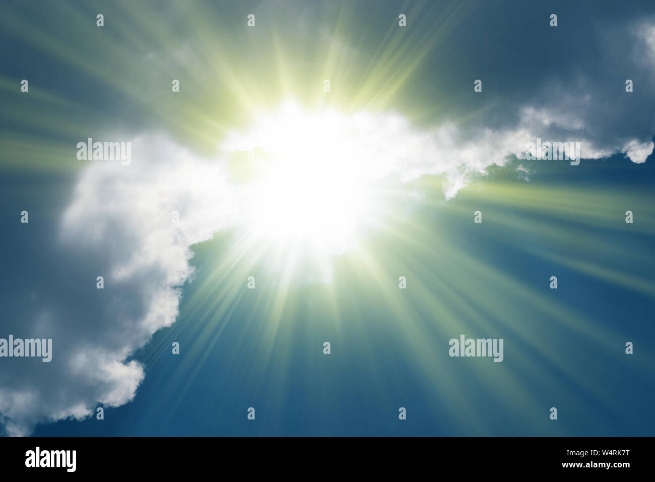 Sun rays sprouting through the clouds Paradise Stock Photo - Alamy