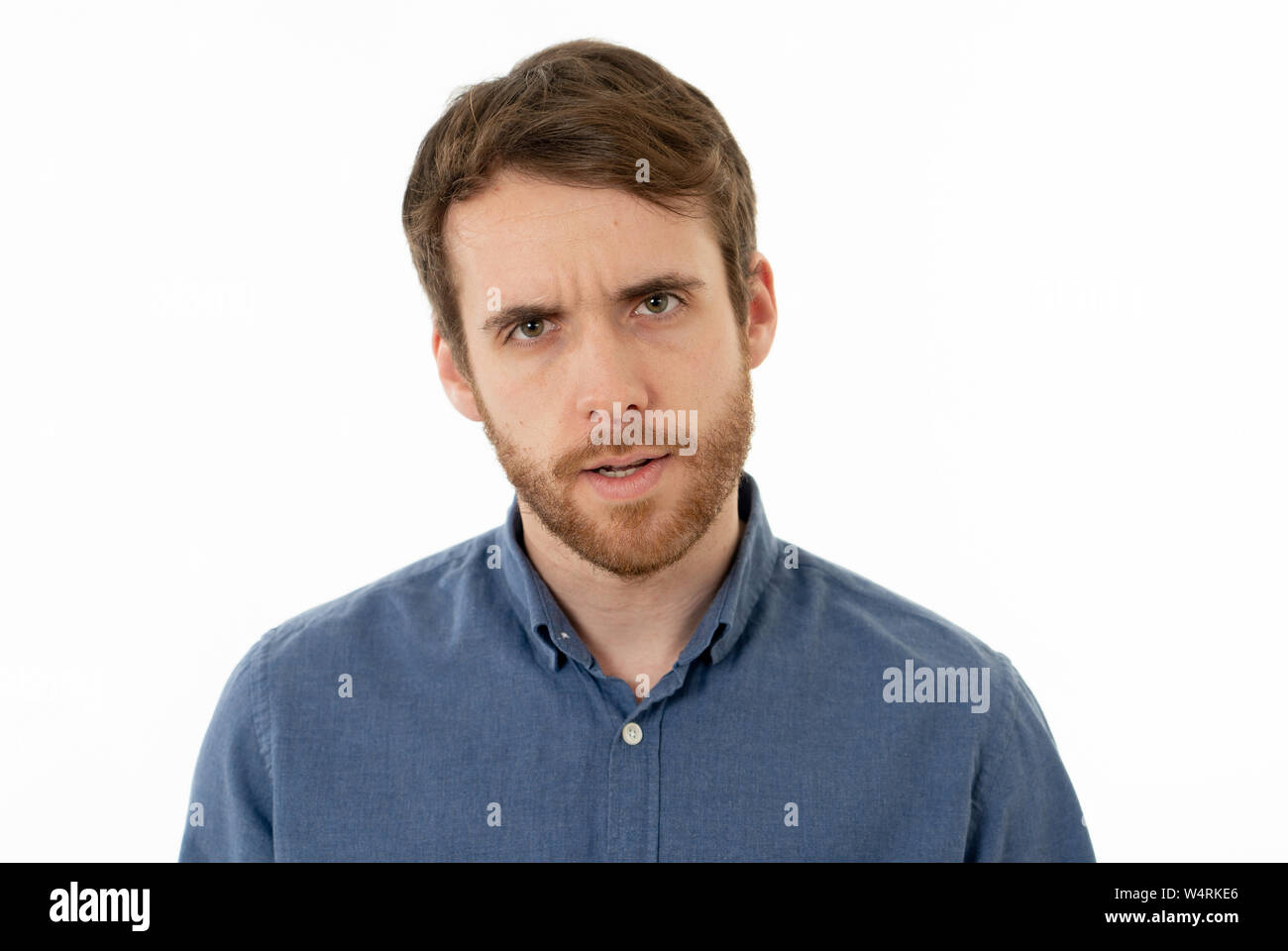 Annoyed young bearded man with an angry face looking mad and furious ...