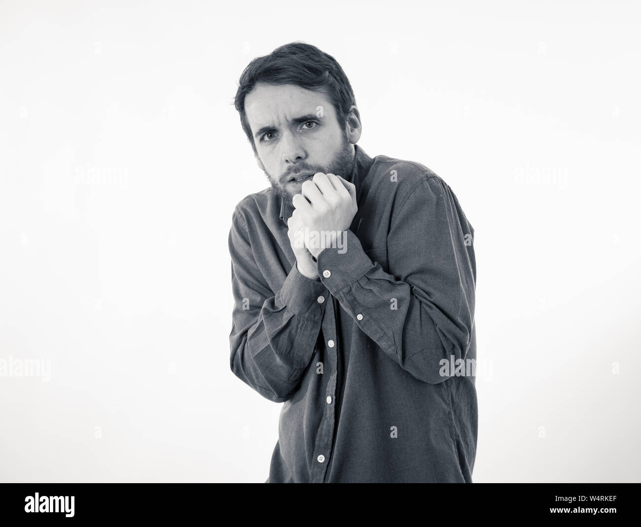 Portrait of young man in shock with scared face paralysed with fear and ...