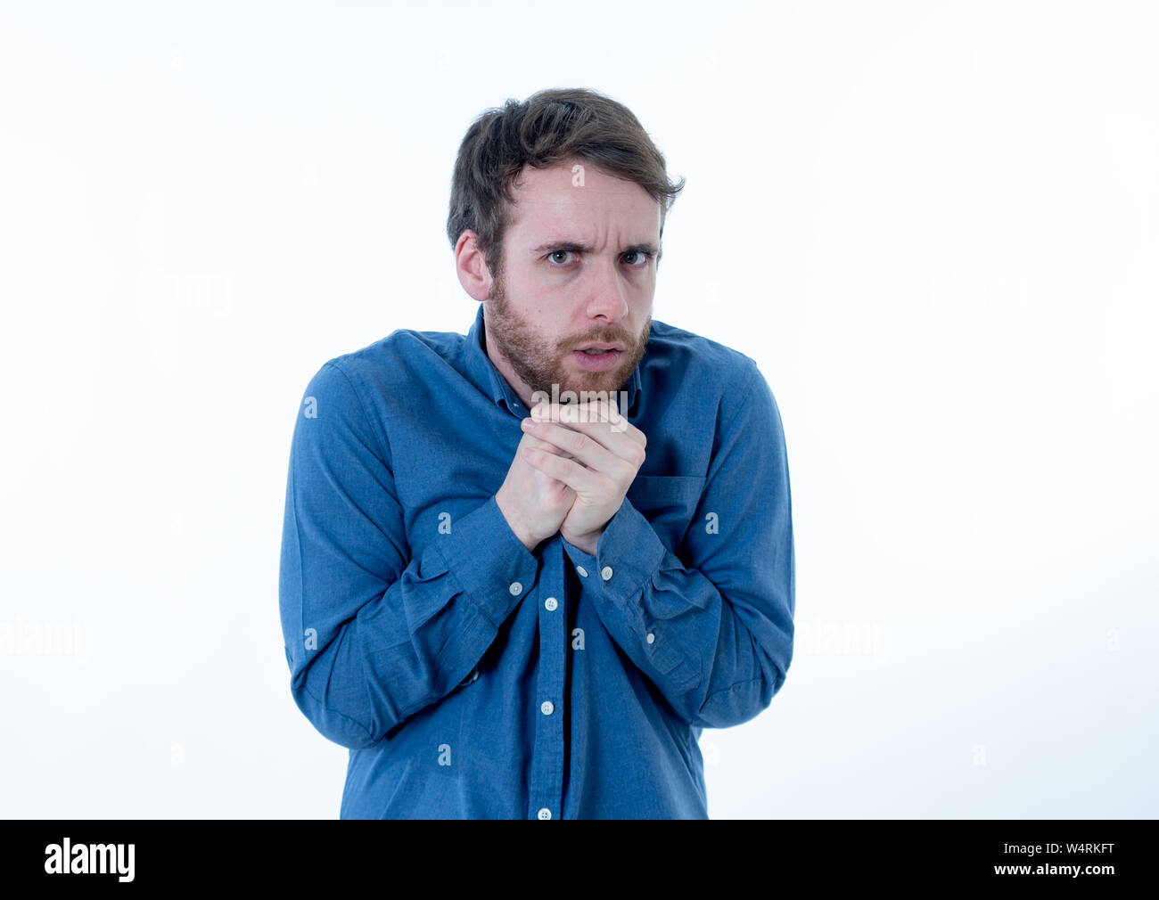 Portrait of young man in shock with scared face paralysed with fear and ...