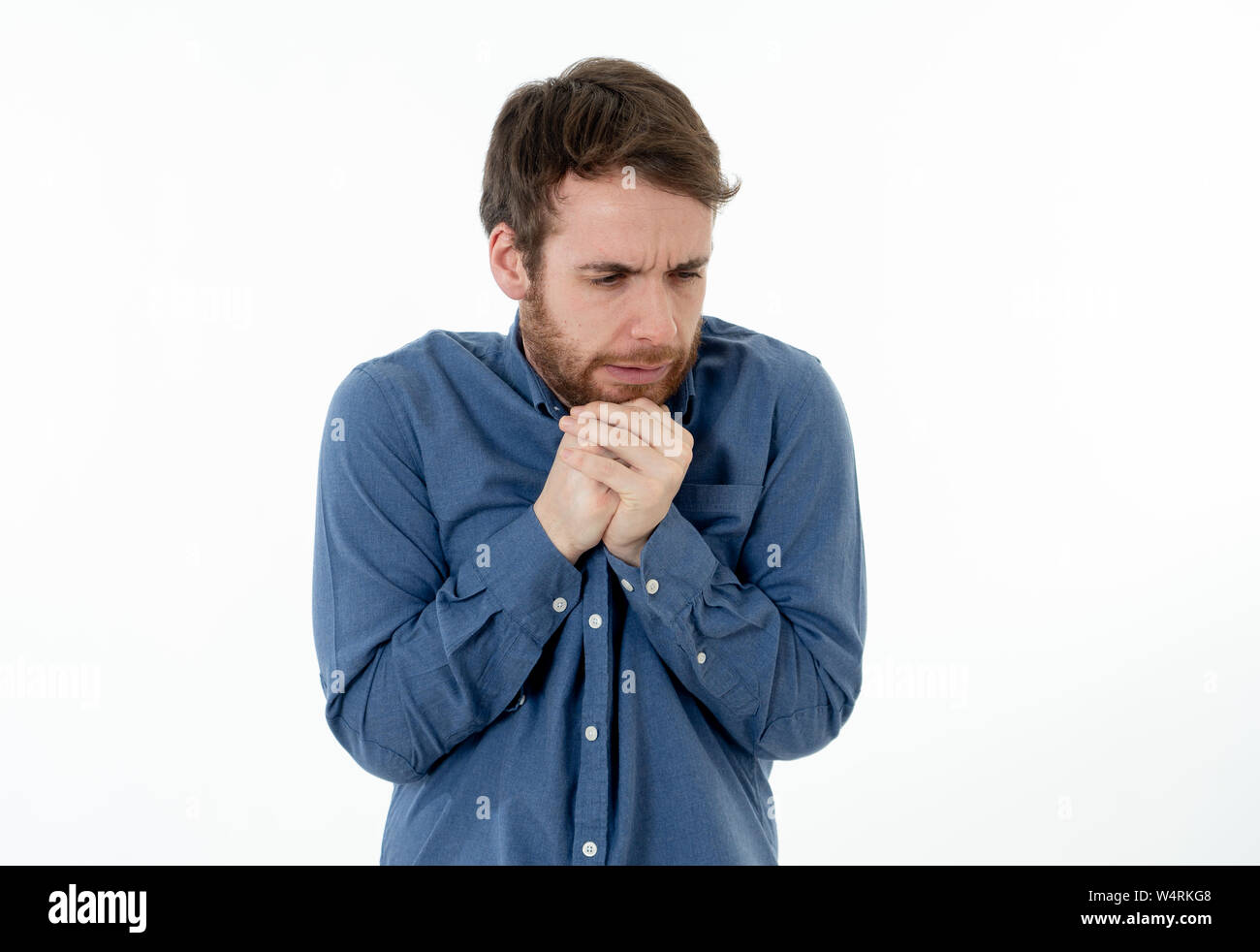 Portrait of young man in shock with scared face paralysed with fear and ...
