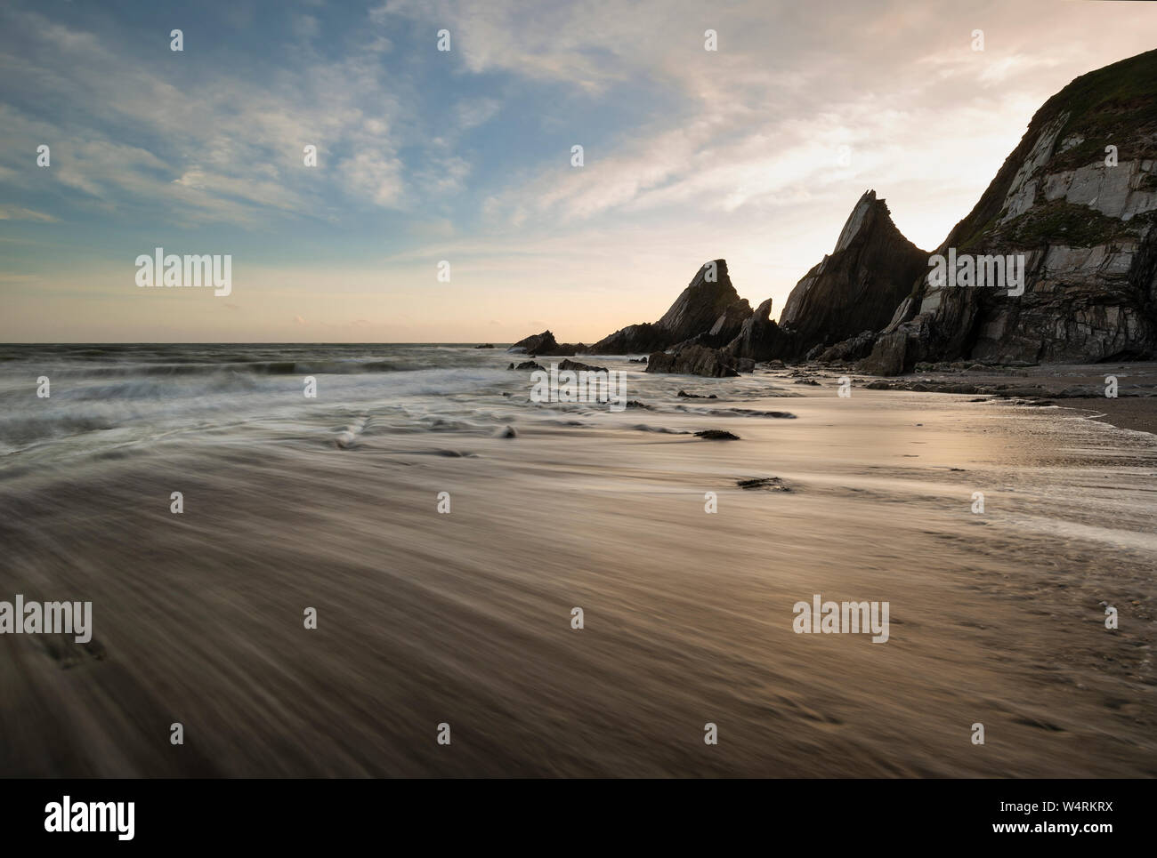 Beautiful sunset landscape image of Westcombe Beach in Devon England ...