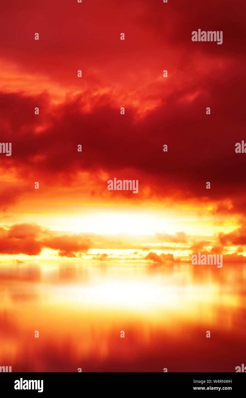 Red sunset over sea, rich dark clouds, Bright sun rays Stock Photo - Alamy
