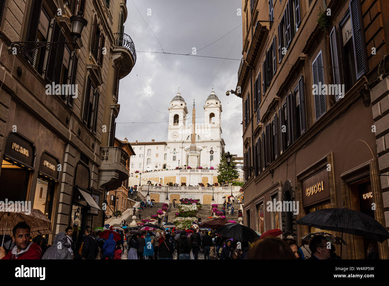 ROME, ITALY - JUNE 28, 2019: crowd of tourists with umbrellas walking ...