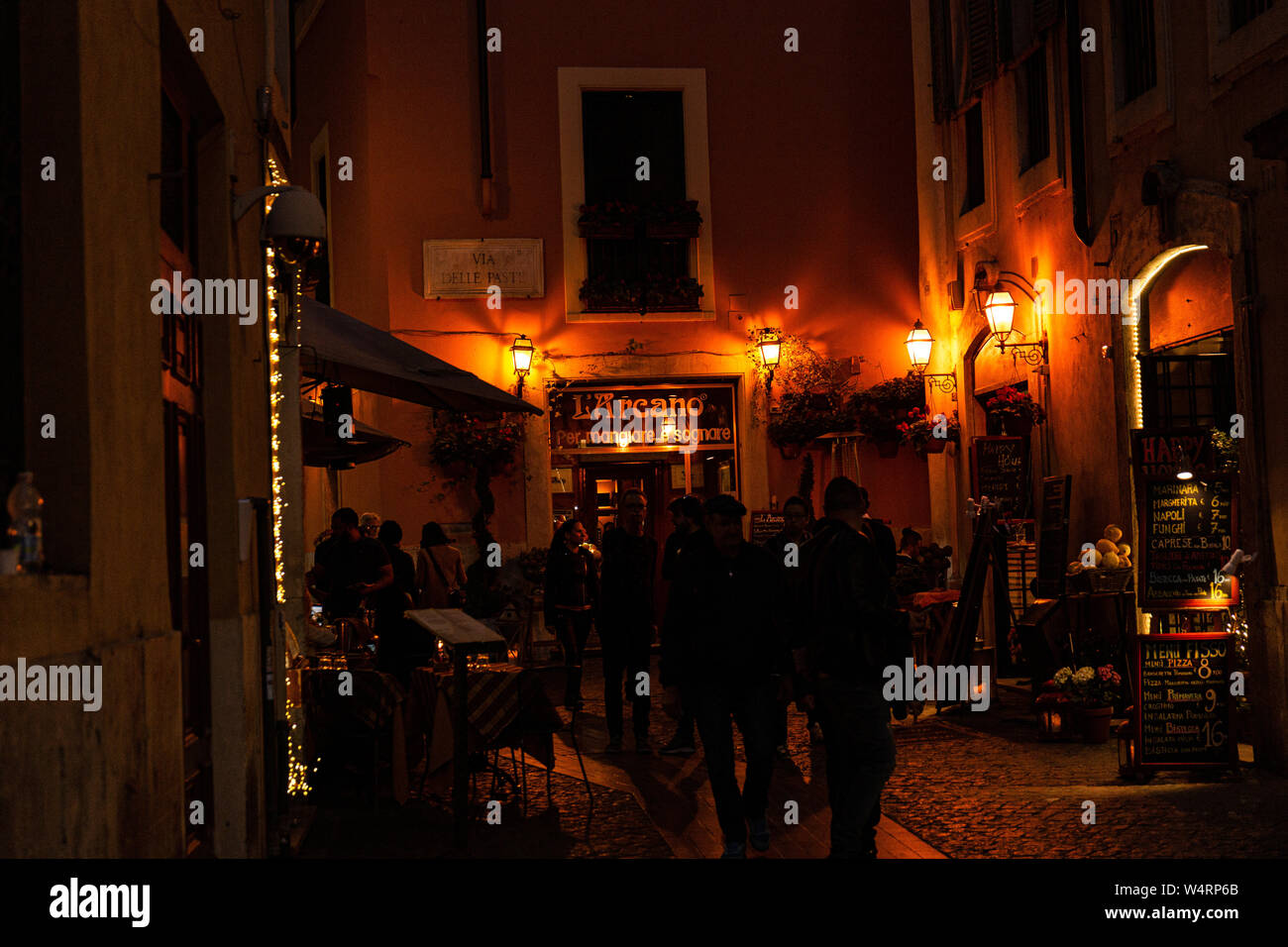 ROME, ITALY - JUNE 28, 2019: crowd of people on dark street at night ...