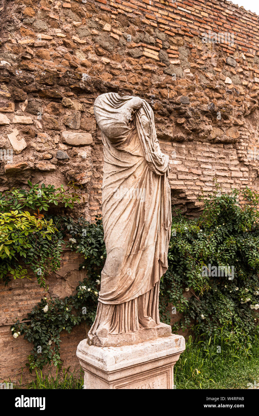 ROME, ITALY - JUNE 28, 2019: ancient headless statue near brick wall ...